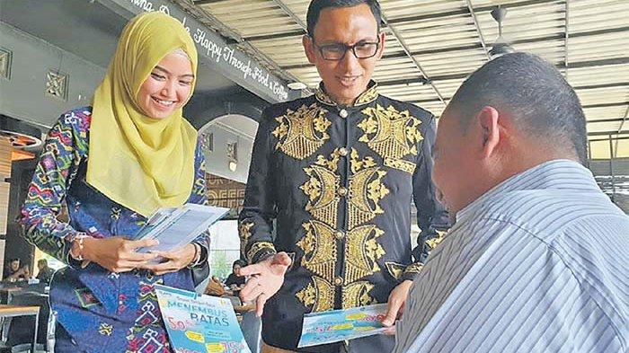 Pegawai PLN Berpakaian Adat Bagikan Bunga - Serambinews.com